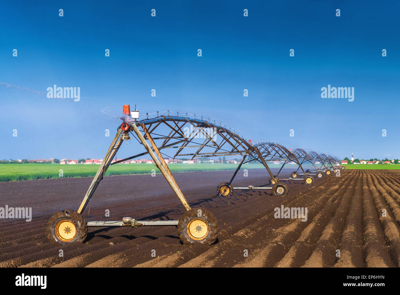 Automated Farming Irrigation Sprinklers System in Operation on ...