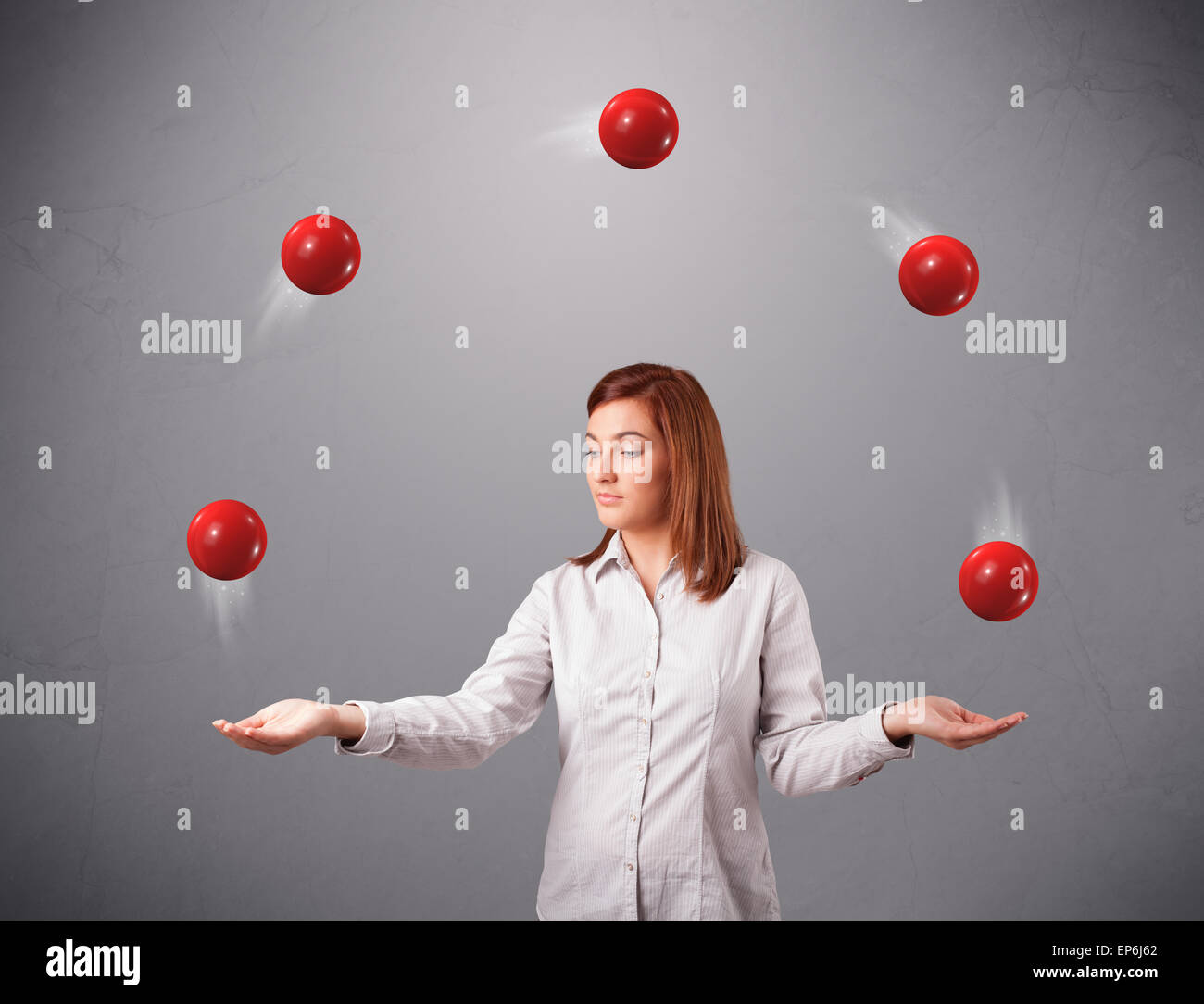 young girl standing and juggling with red balls Stock Photo - Alamy