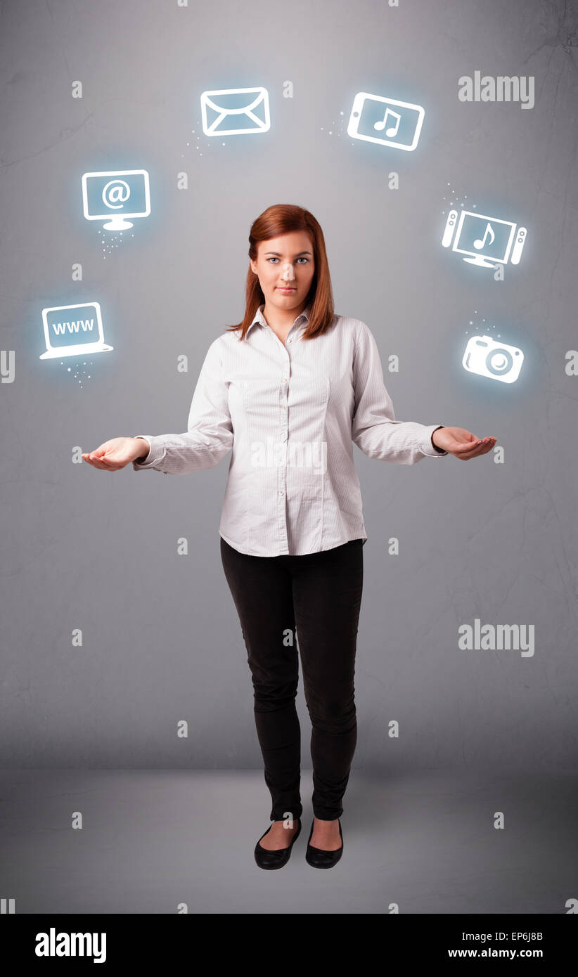 pretty girl juggling with elecrtonic devices icons Stock Photo - Alamy