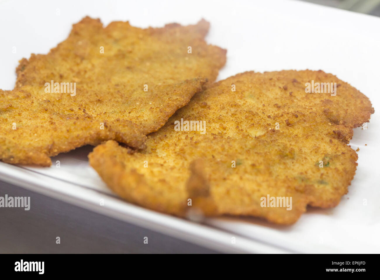 Breaded fried chicken cutlets on platter on display at restauant Stock ...