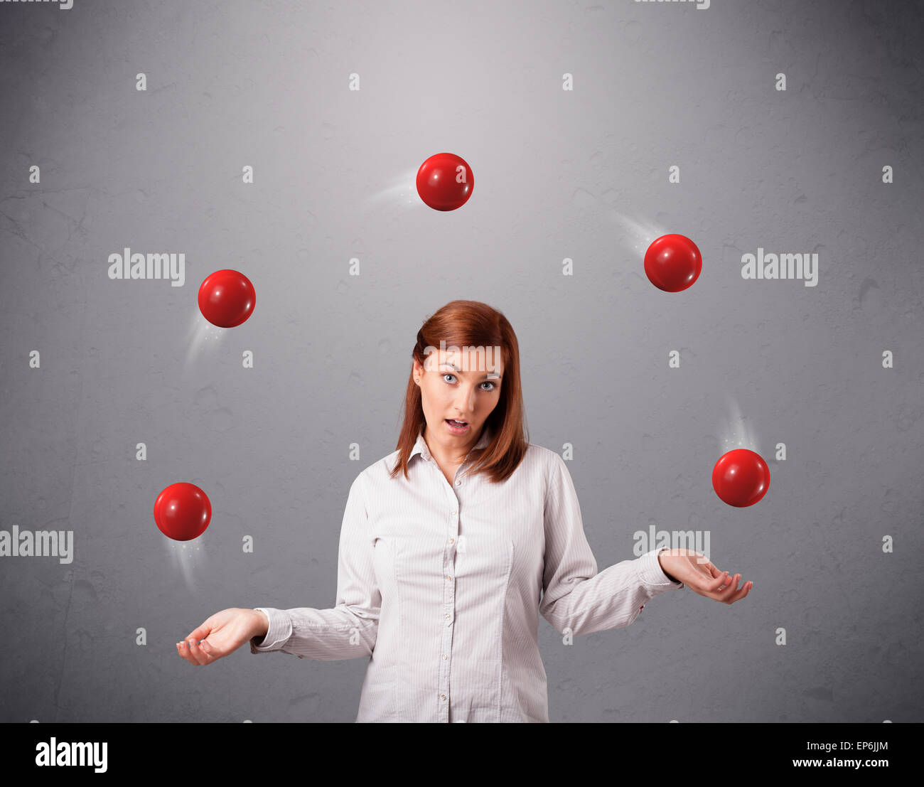 young girl standing and juggling with red balls Stock Photo - Alamy