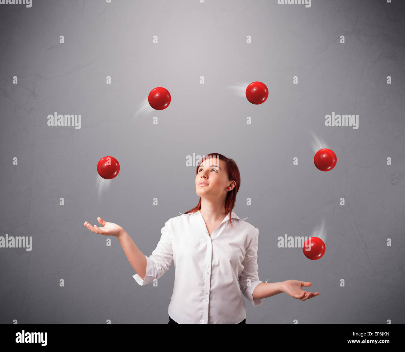 young girl standing and juggling with red balls Stock Photo - Alamy