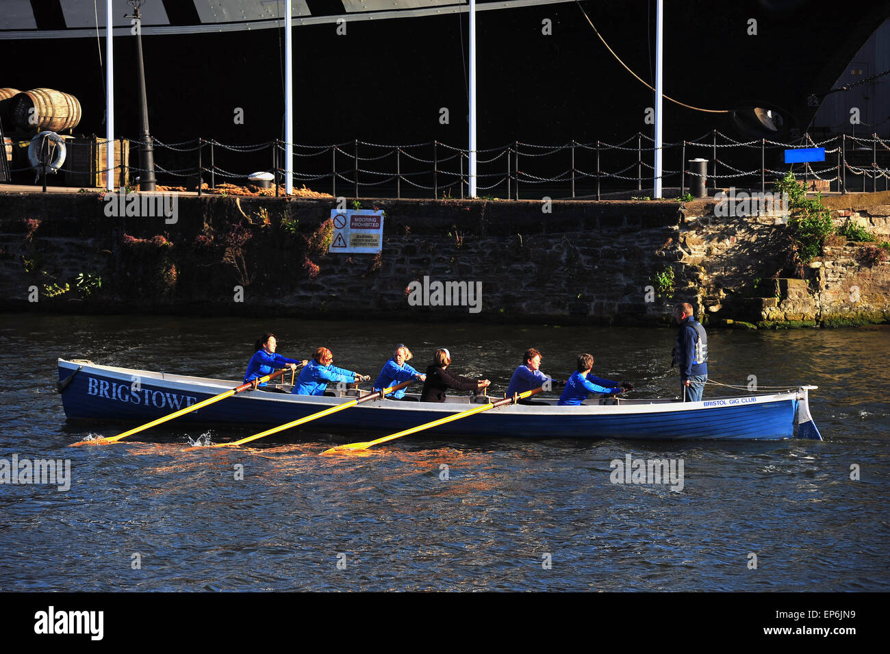 A rowing boat passes the SS Great Britain in the waters of Bristol ...