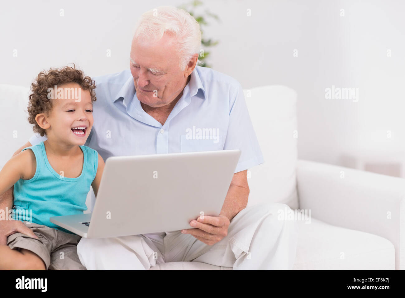 Grandfather and his grandson watching a laptop screen Stock Photo - Alamy