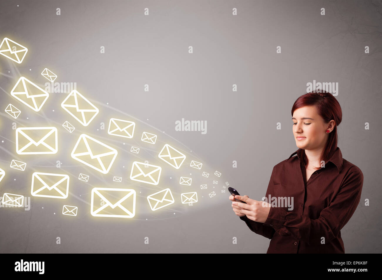 attractive young lady holding a phone with message icons Stock Photo ...