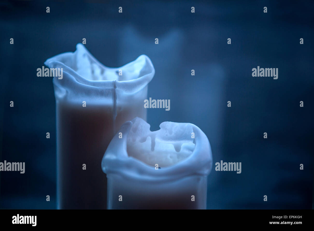 Extinct candles in blue in front of a dark background Stock Photo - Alamy