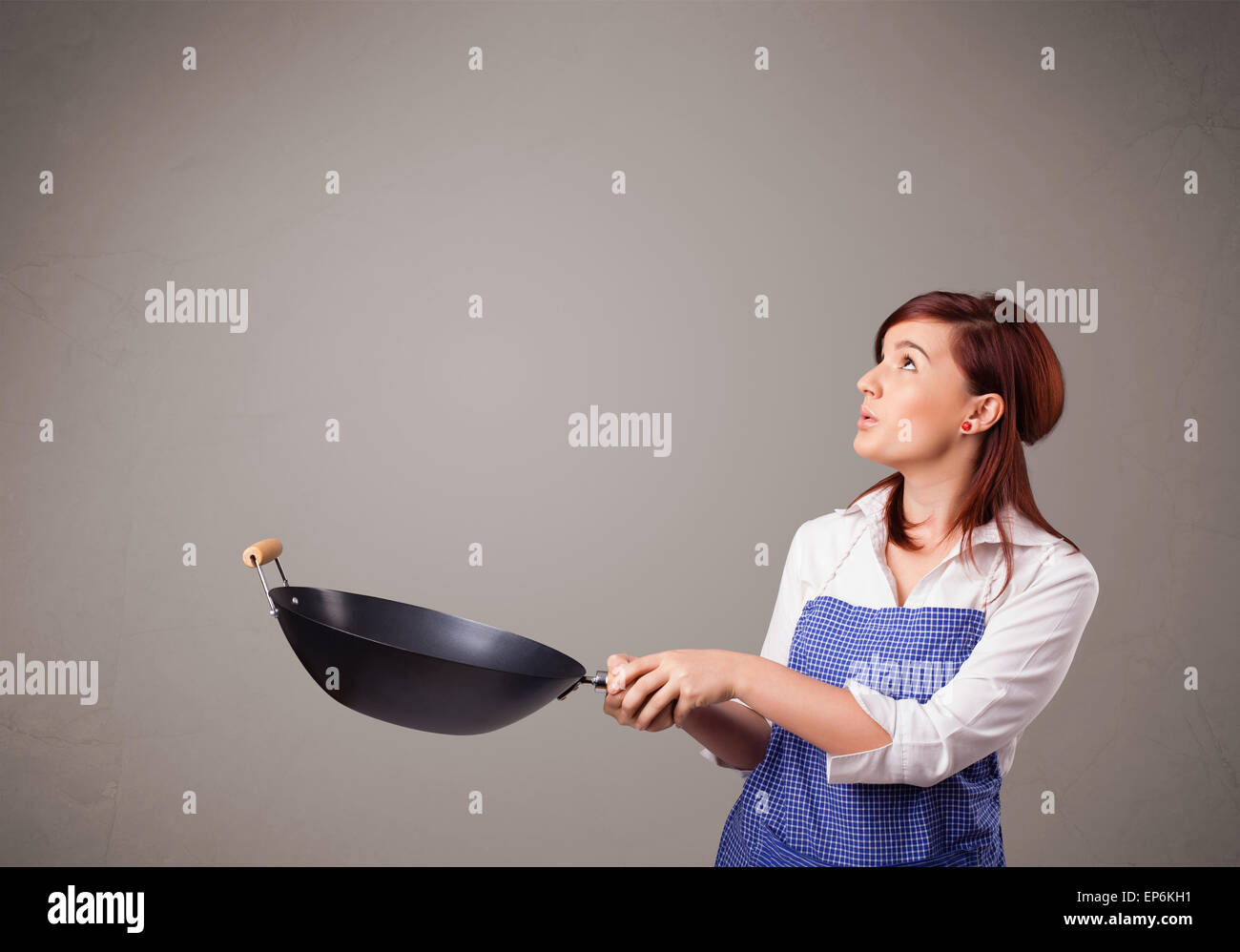 Young lady holding a frying pan Stock Photo - Alamy