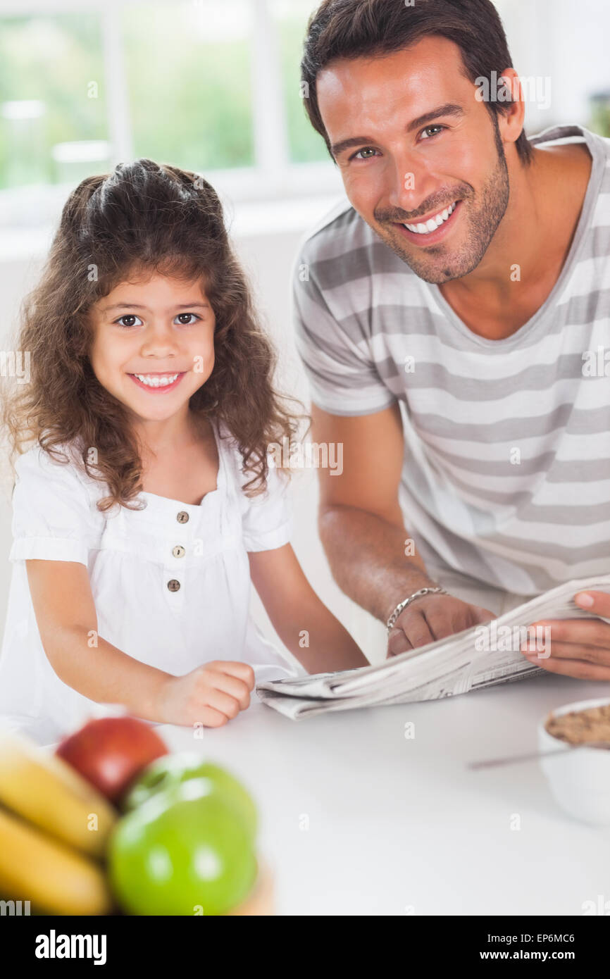 Dad and daughter reading a newspaper during breakfast Stock Photo - Alamy