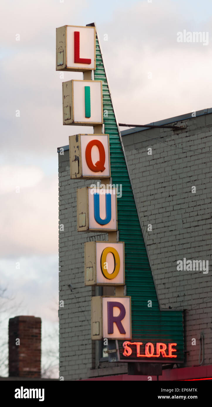 A multi color sign outside of a store that sells alcohol Stock Photo ...