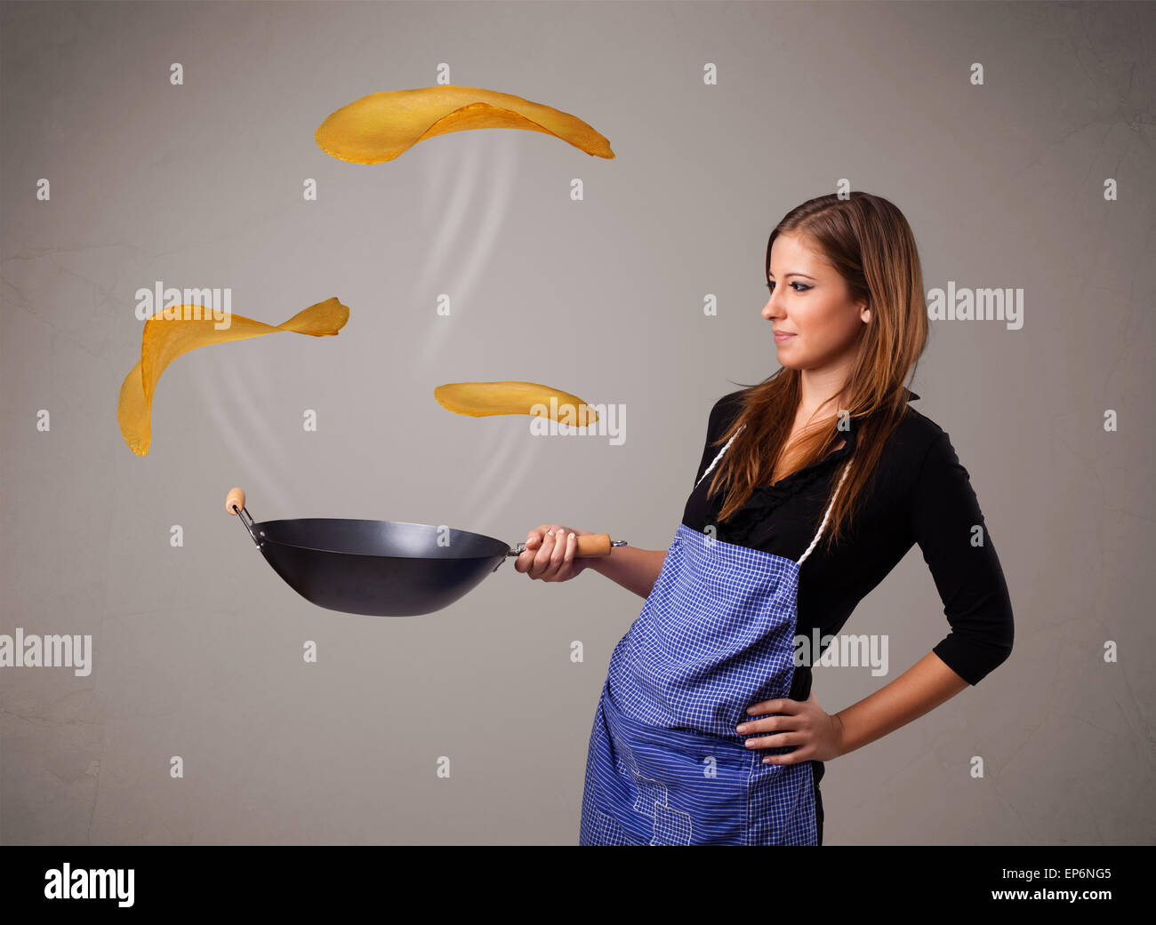 Woman making pancakes Stock Photo - Alamy