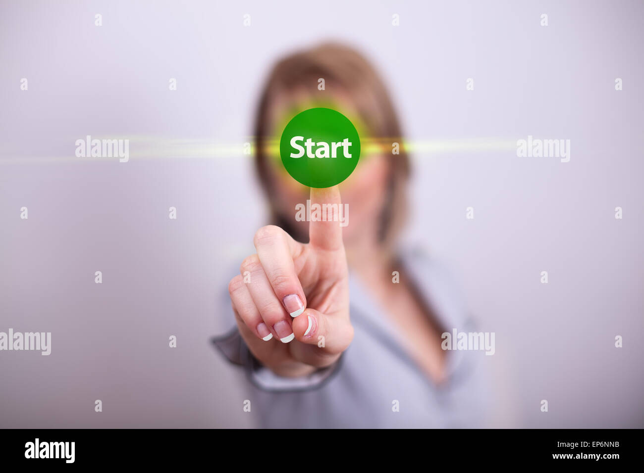 Woman pressing start button Stock Photo - Alamy