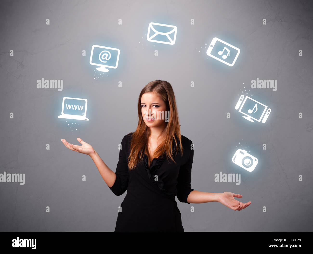 pretty girl juggling with elecrtonic devices icons Stock Photo - Alamy