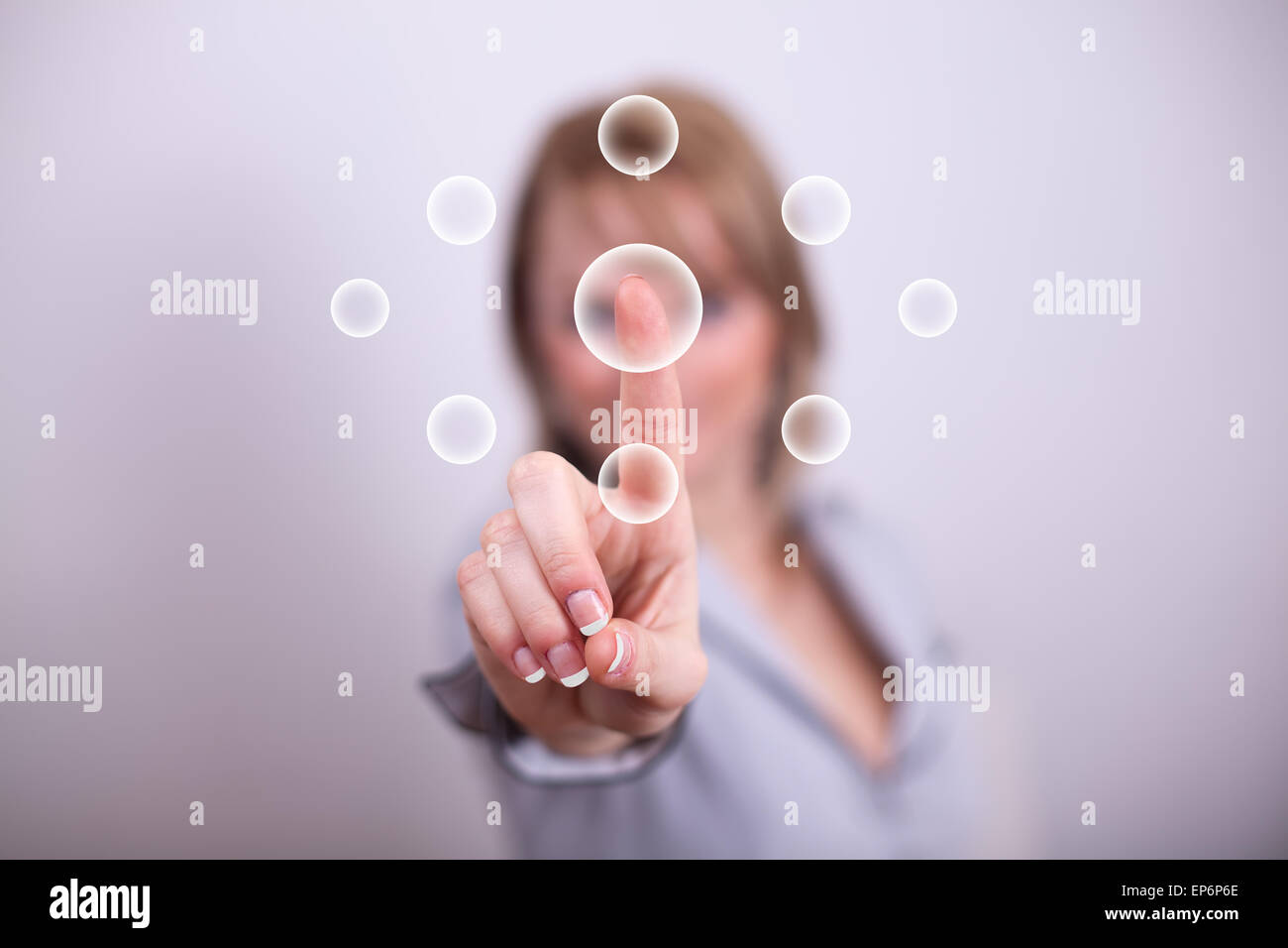Woman pressing modern circular button Stock Photo - Alamy