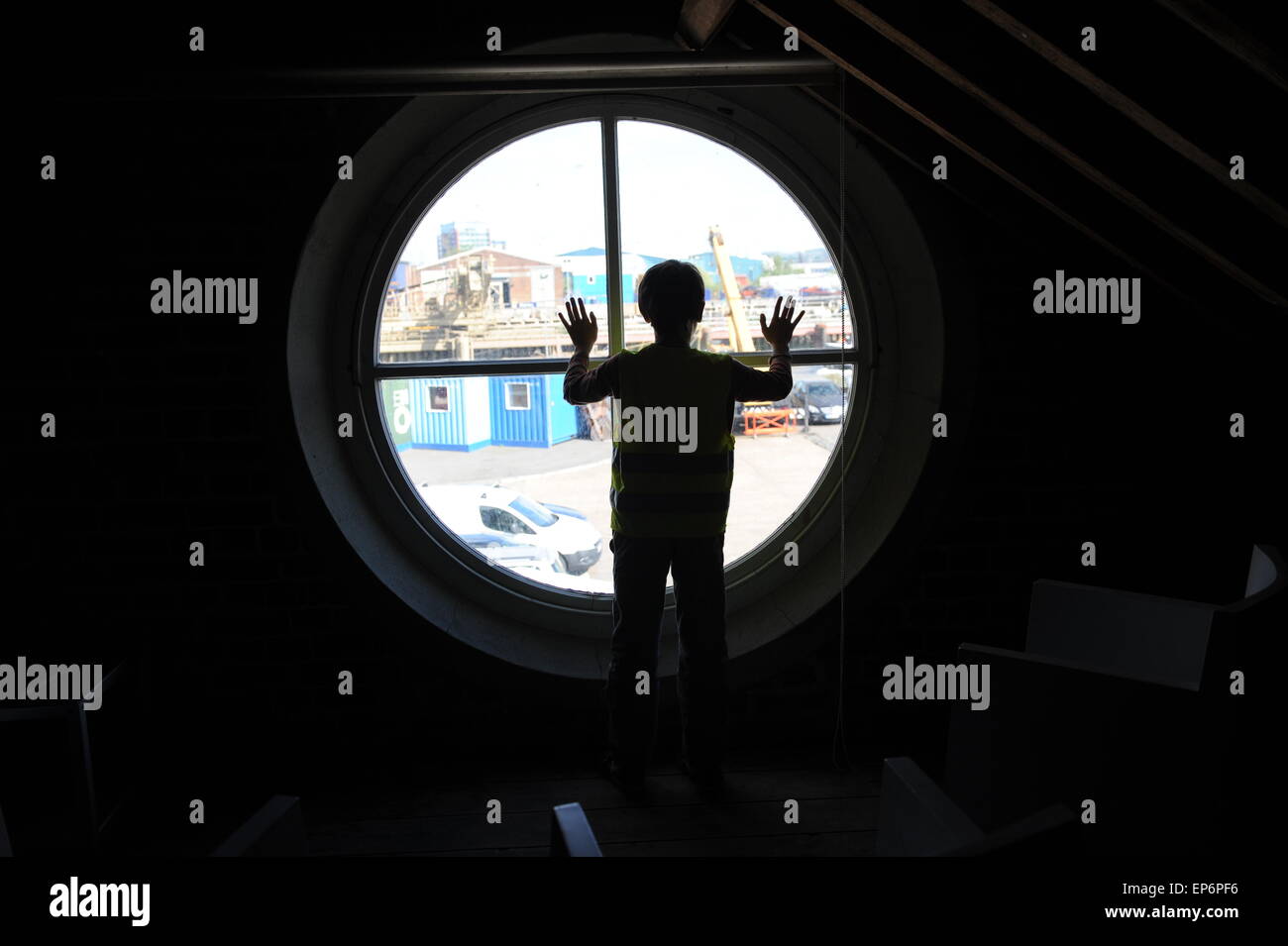 10 year old English boy looking out of the lighthouse window in Trinity ...