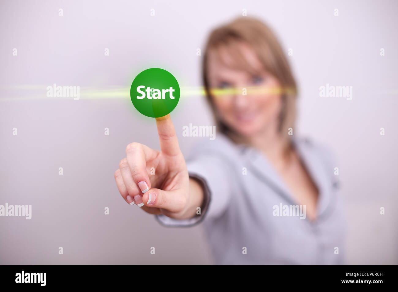 Woman pressing start button Stock Photo - Alamy