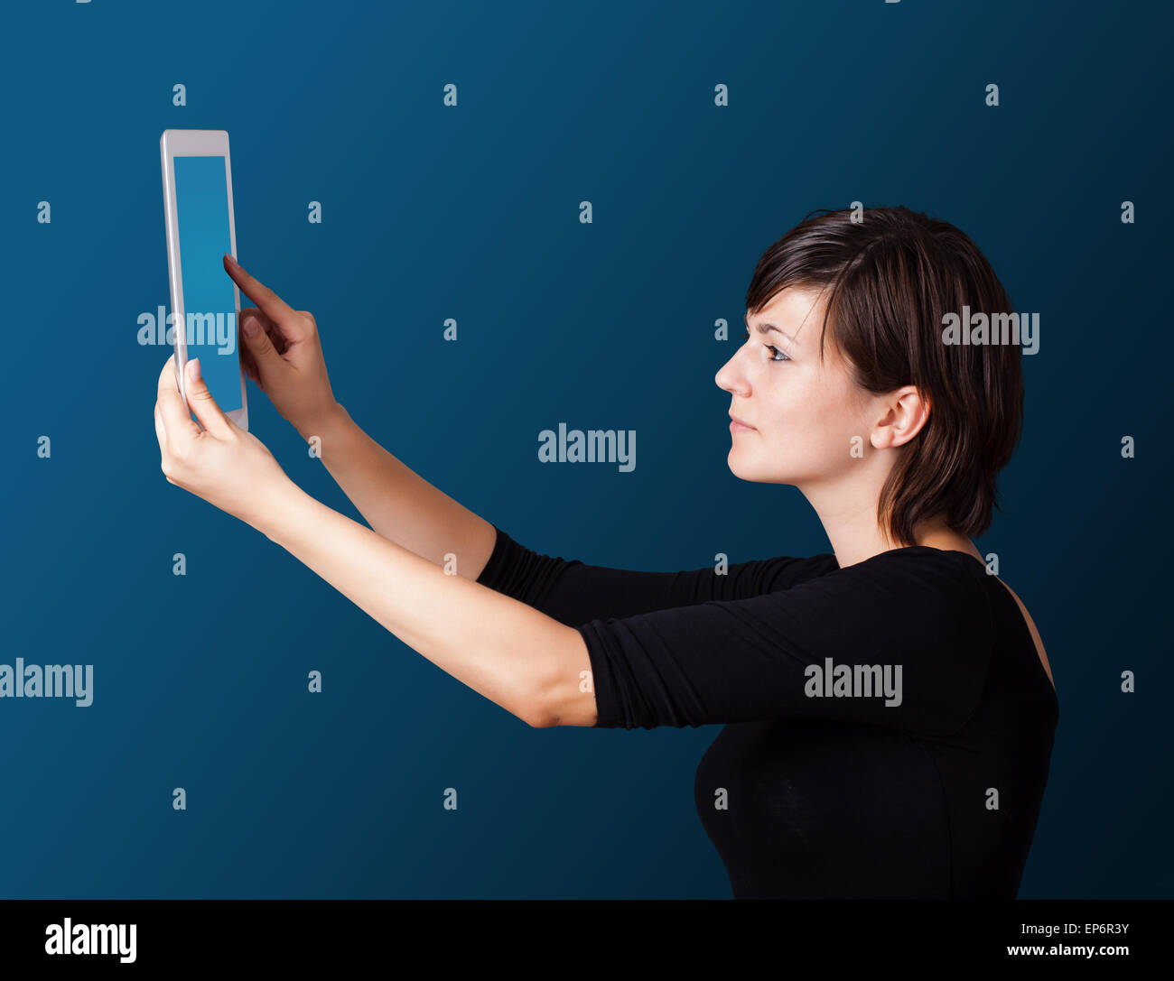 Young woman looking at modern tablet Stock Photo - Alamy