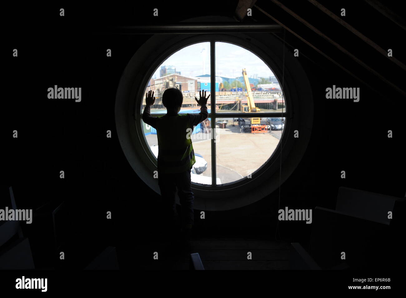 10 year old English boy looking out of the lighthouse window in Trinity ...