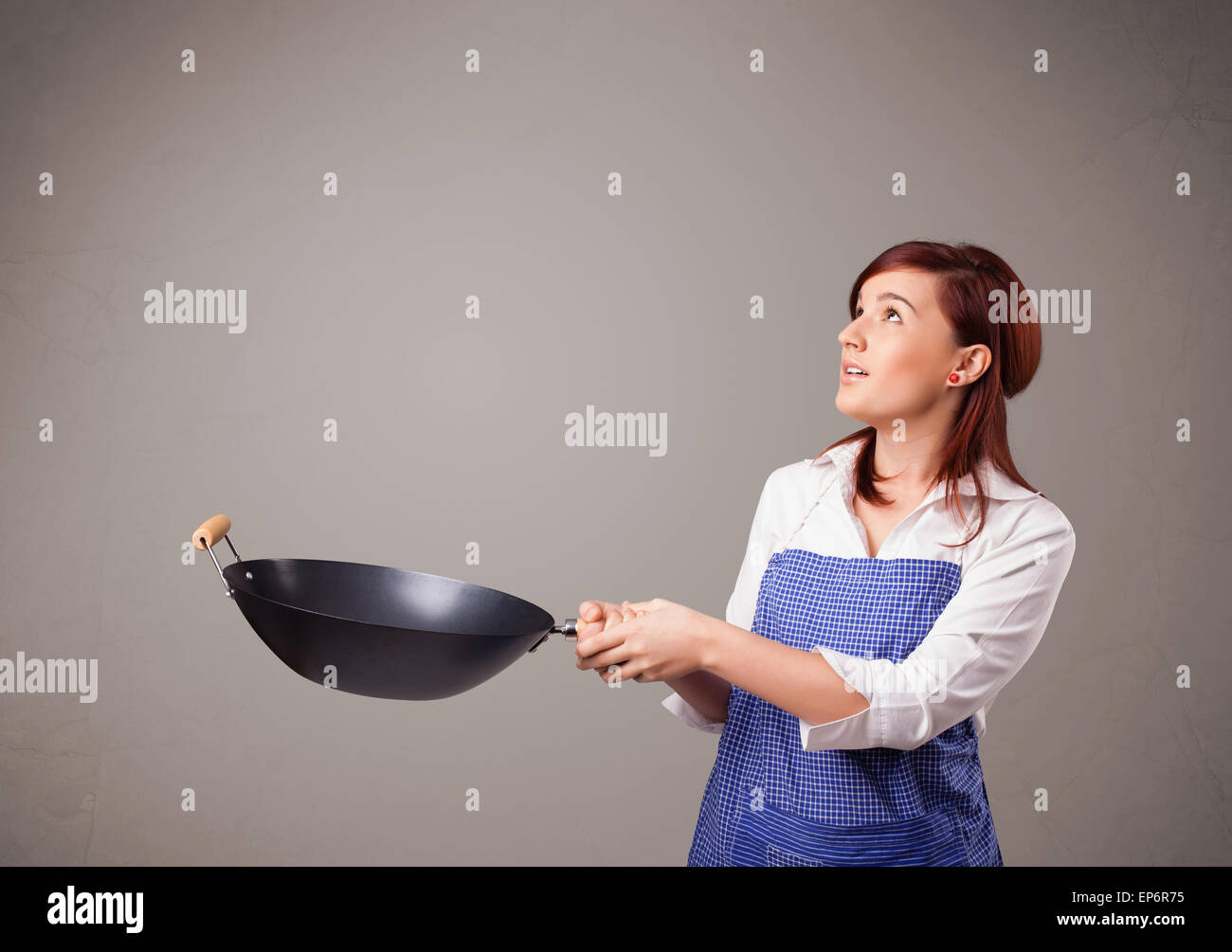 Young lady holding a frying pan Stock Photo - Alamy
