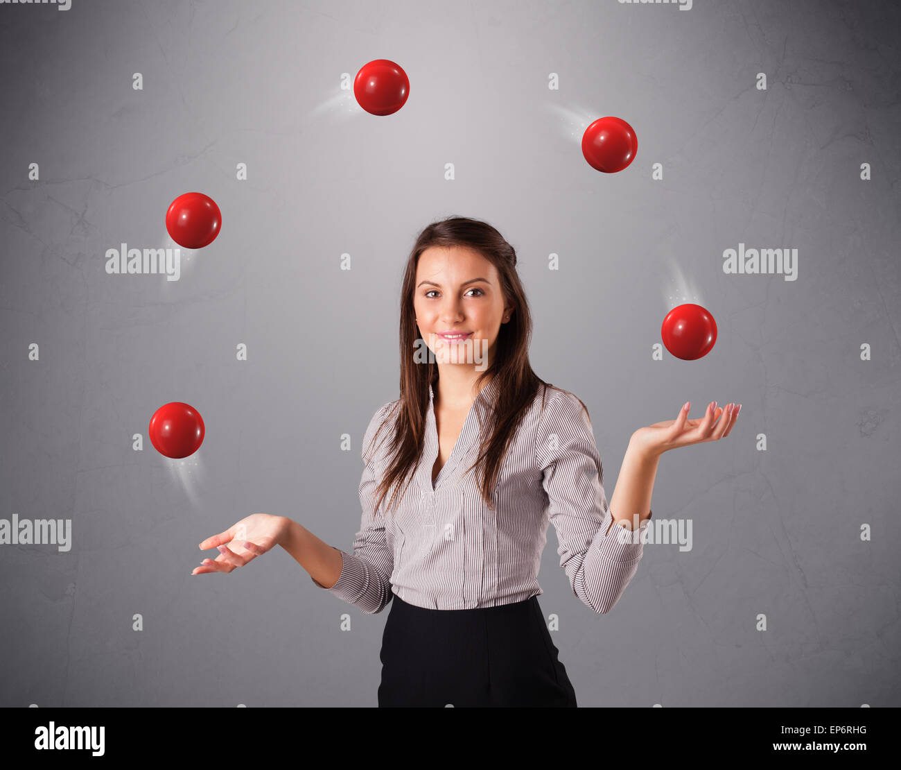 young girl standing and juggling with red balls Stock Photo - Alamy