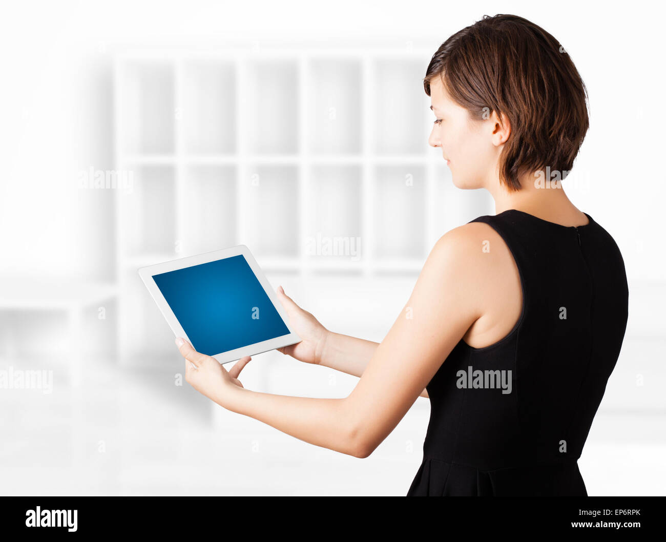 Young woman looking at modern tablet Stock Photo - Alamy