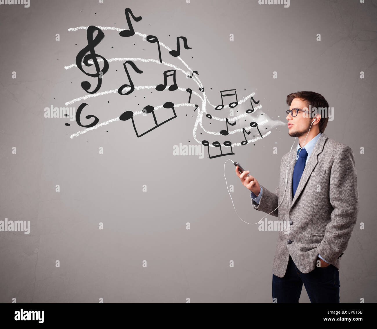 handsome boy singing and listening to music with musical notes Stock ...