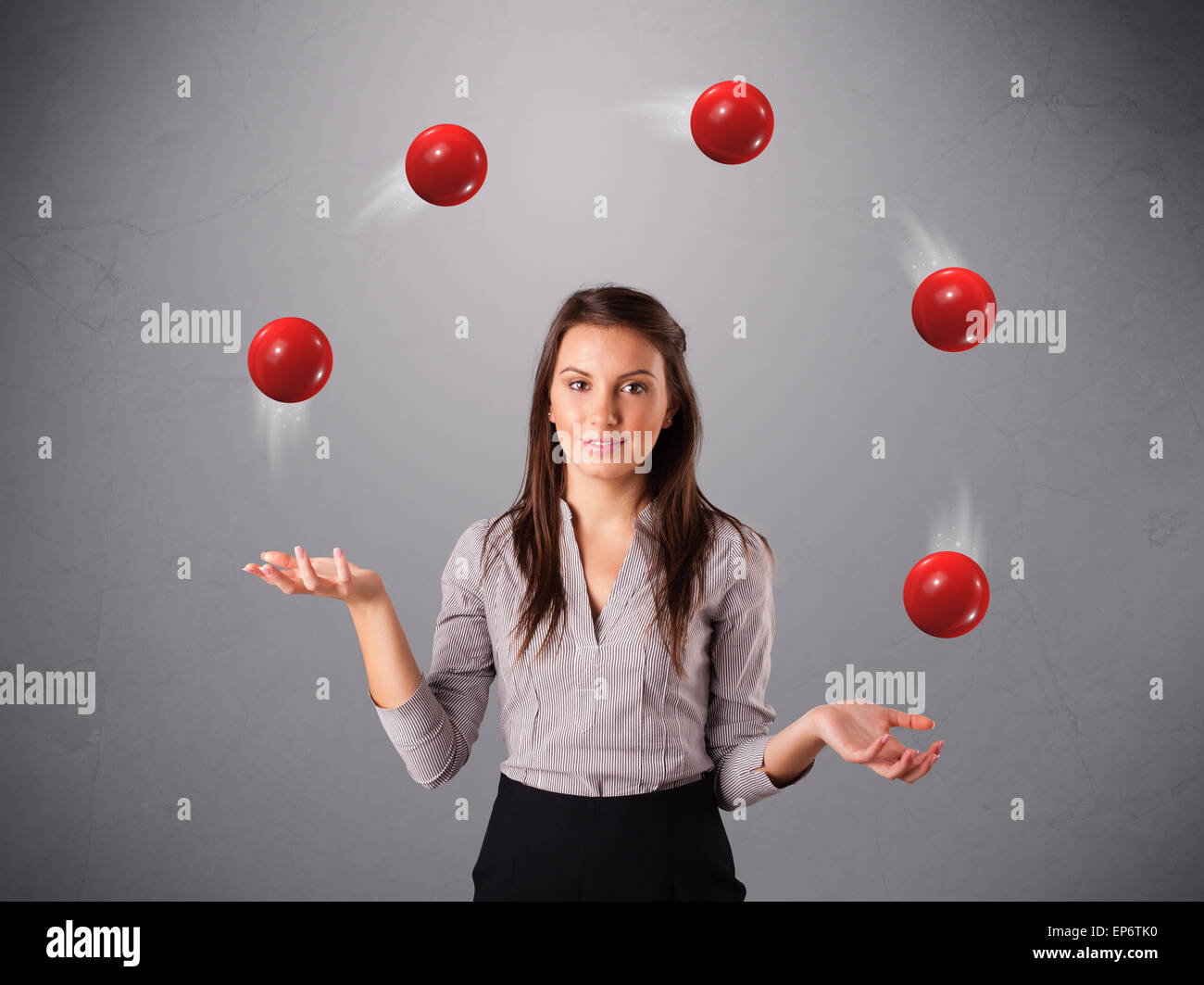 young girl standing and juggling with red balls Stock Photo - Alamy