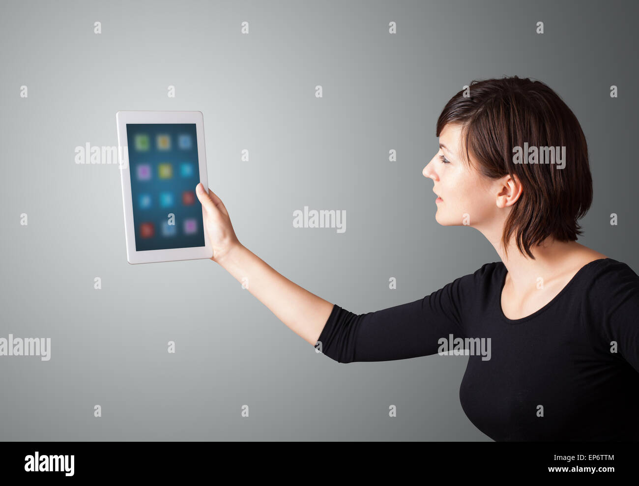 woman holding modern tablet with colorful icons Stock Photo - Alamy