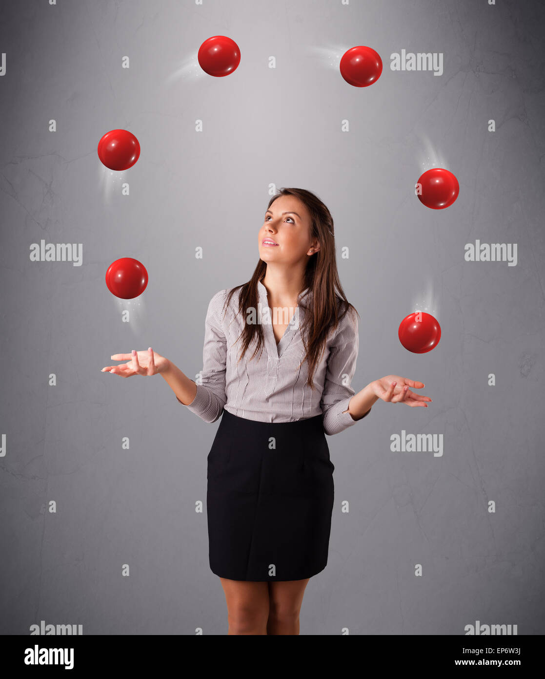 young girl standing and juggling with red balls Stock Photo - Alamy