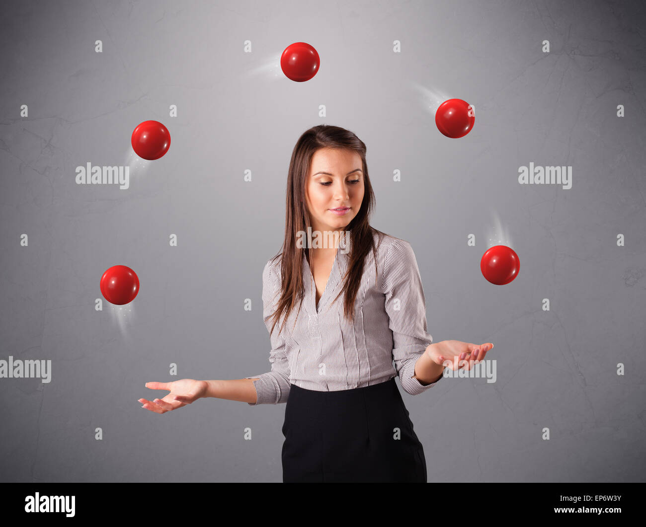 young girl standing and juggling with red balls Stock Photo - Alamy