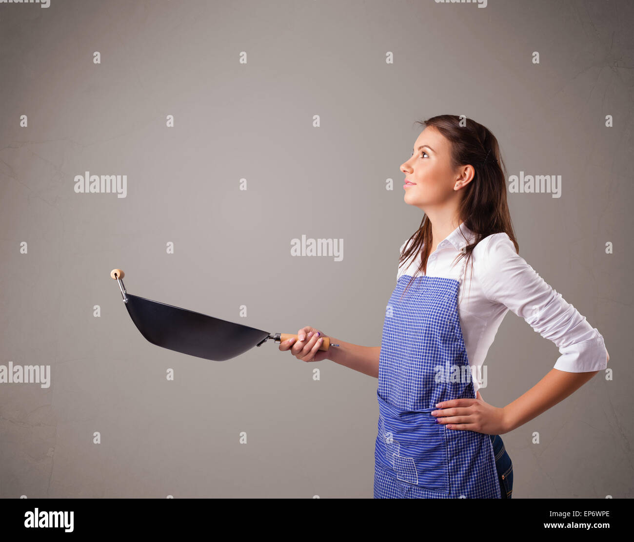 Young lady holding a frying pan Stock Photo - Alamy