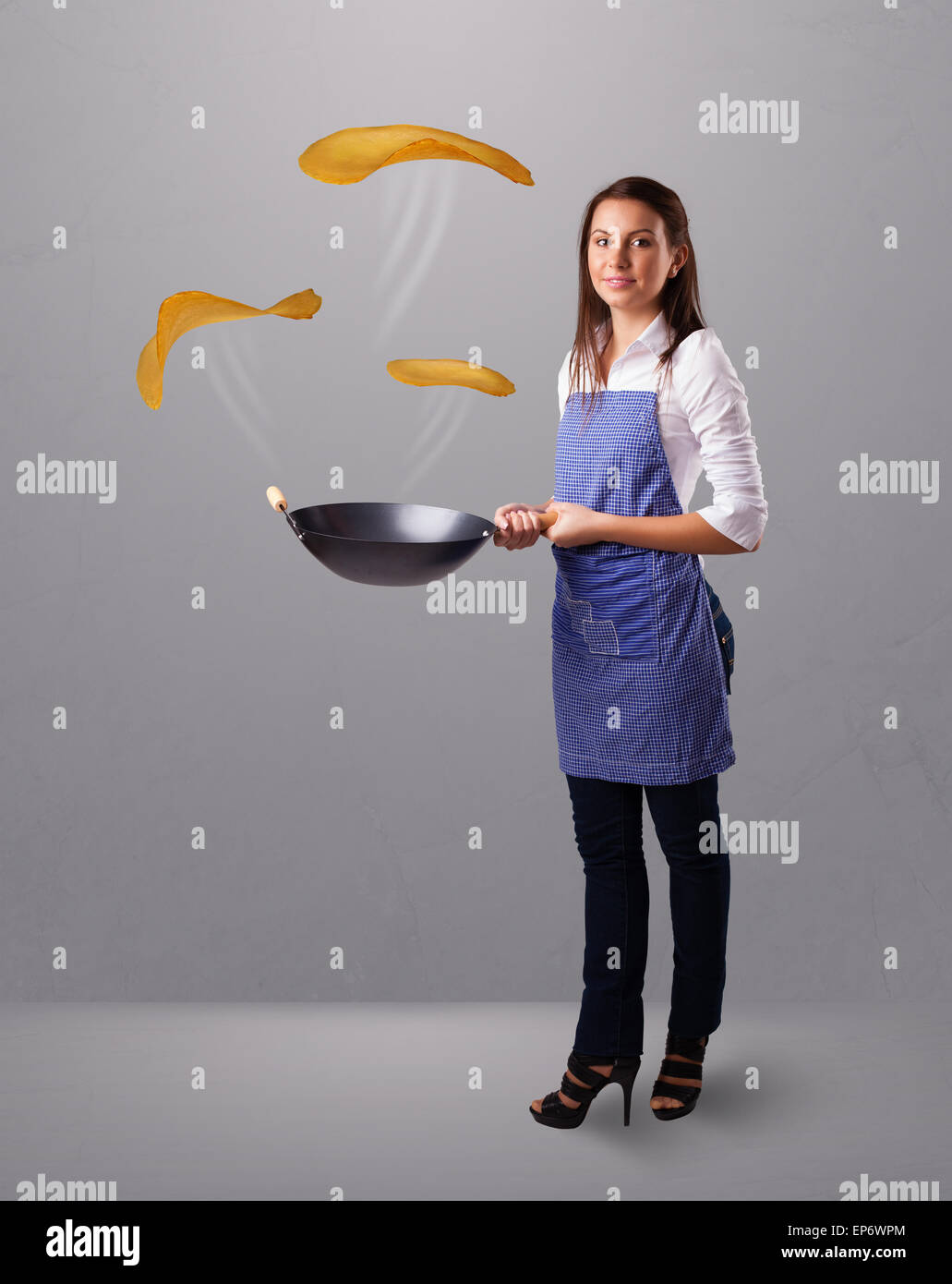 Woman making pancakes Stock Photo - Alamy