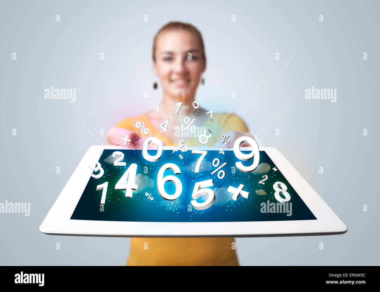 Young woman holding tablet with numbers Stock Photo - Alamy