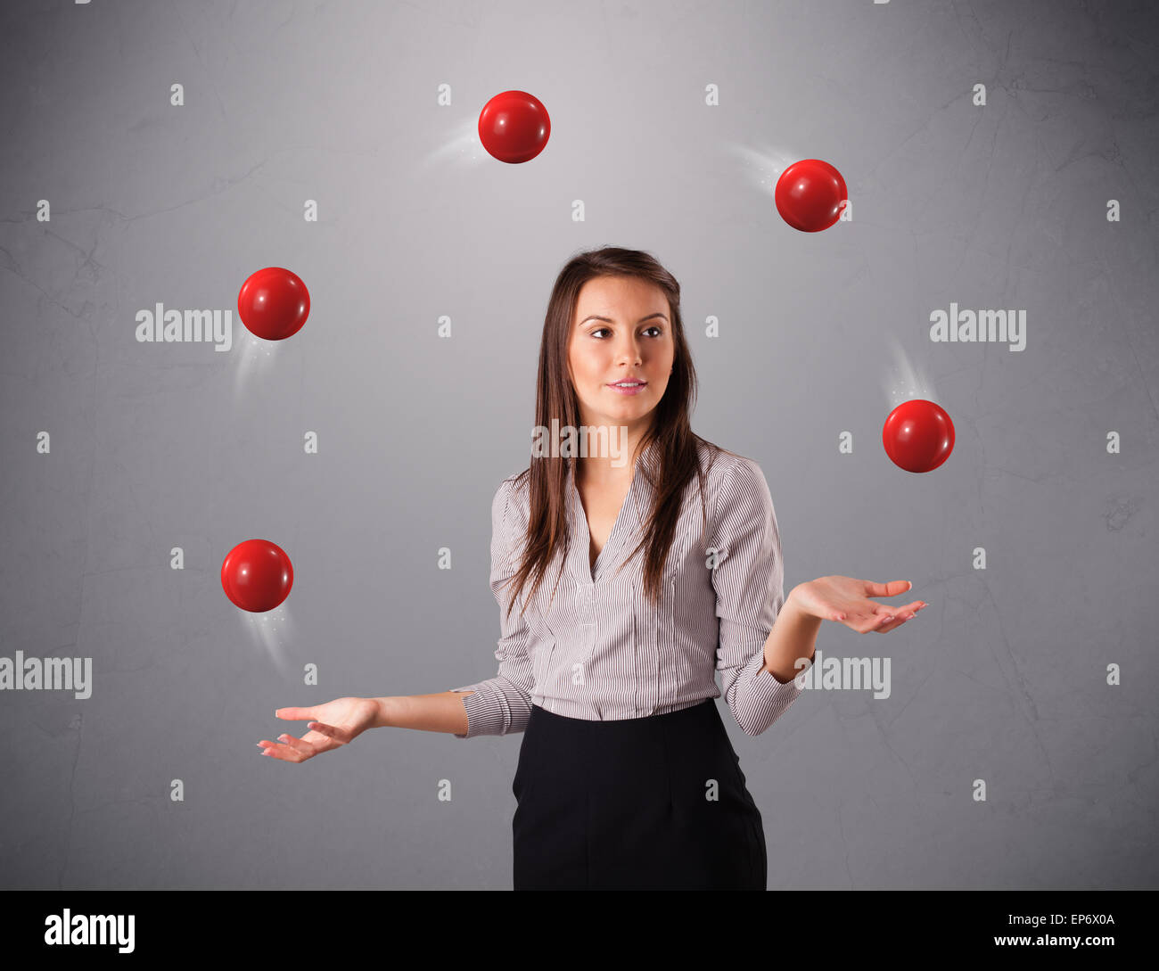 young girl standing and juggling with red balls Stock Photo - Alamy