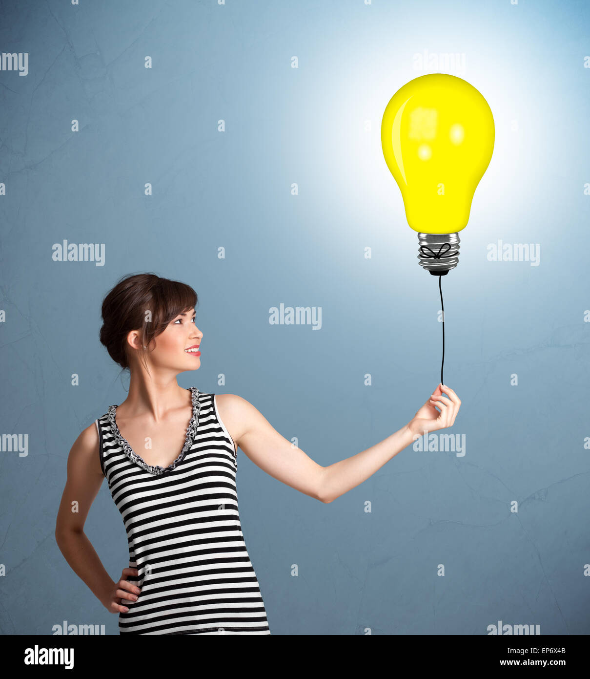 Pretty lady holding a light bulb balloon Stock Photo - Alamy