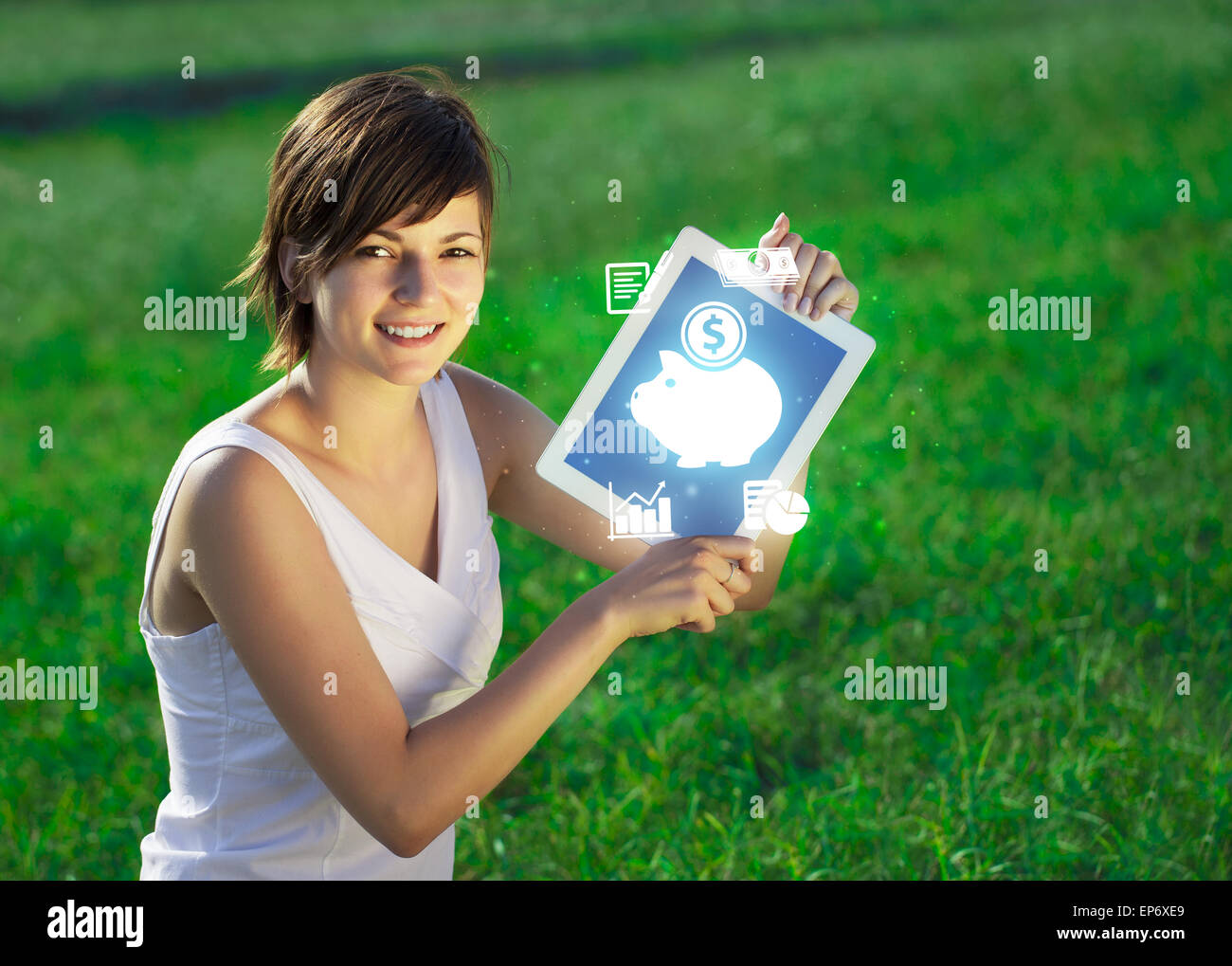 Young woman looking at modern tablet with abstract light and various ...