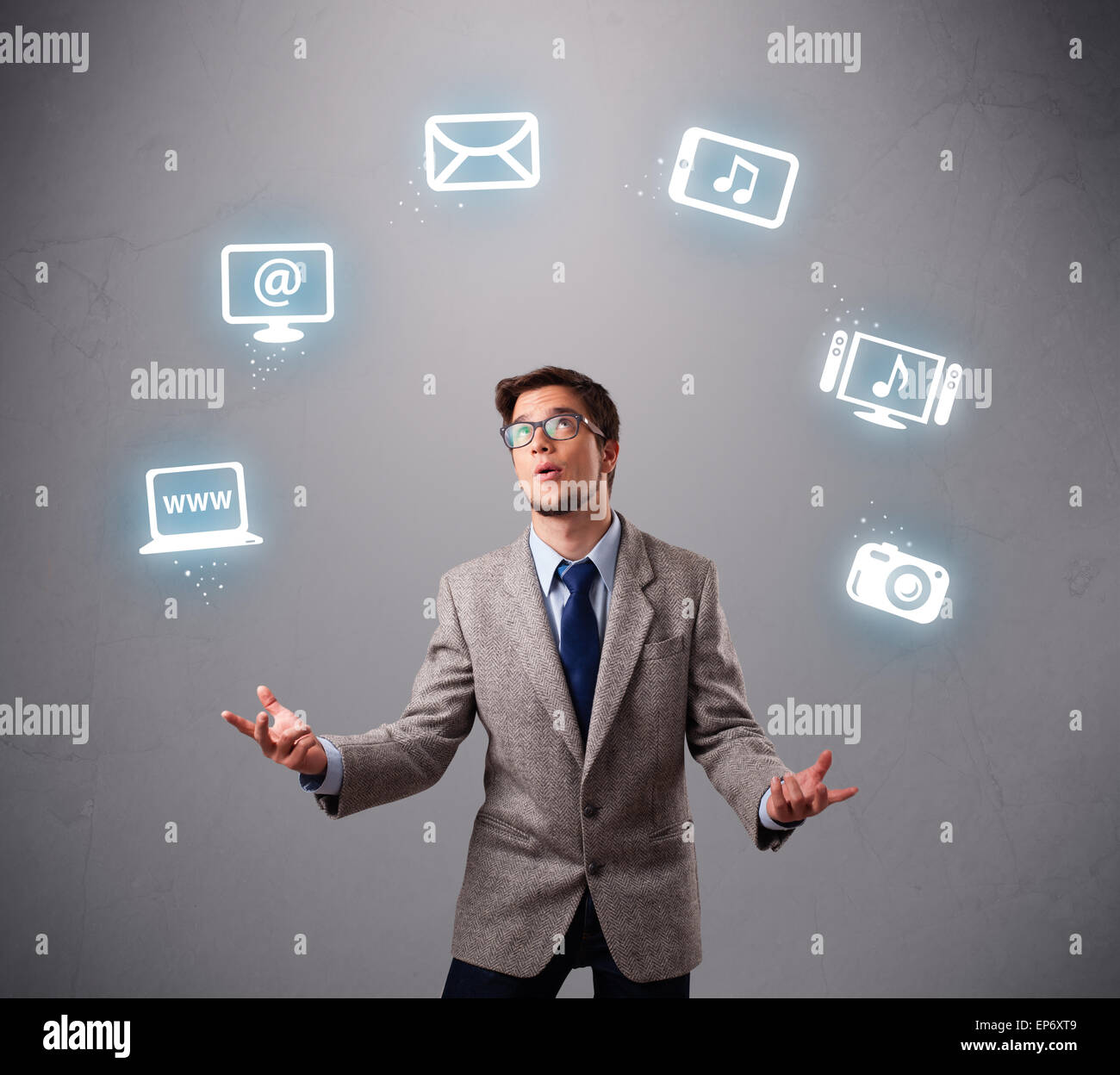 funny boy juggling with electronic devices icons Stock Photo - Alamy
