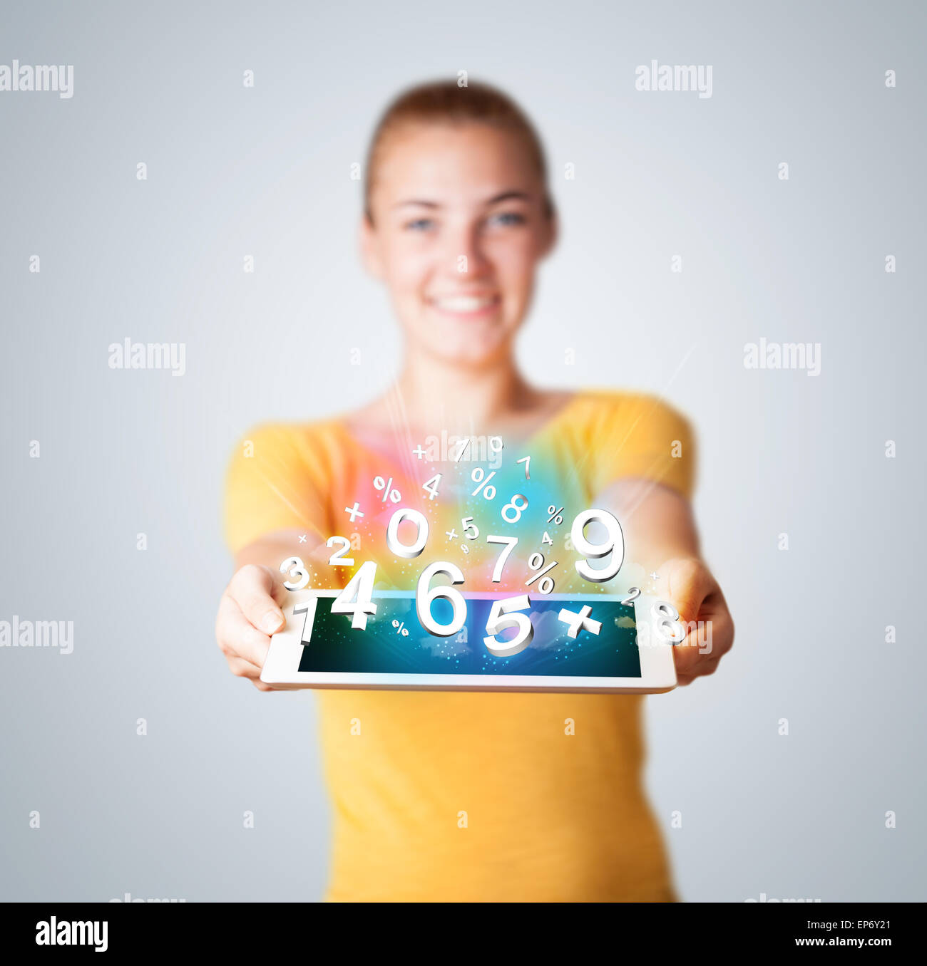 Young woman holding tablet with numbers Stock Photo - Alamy