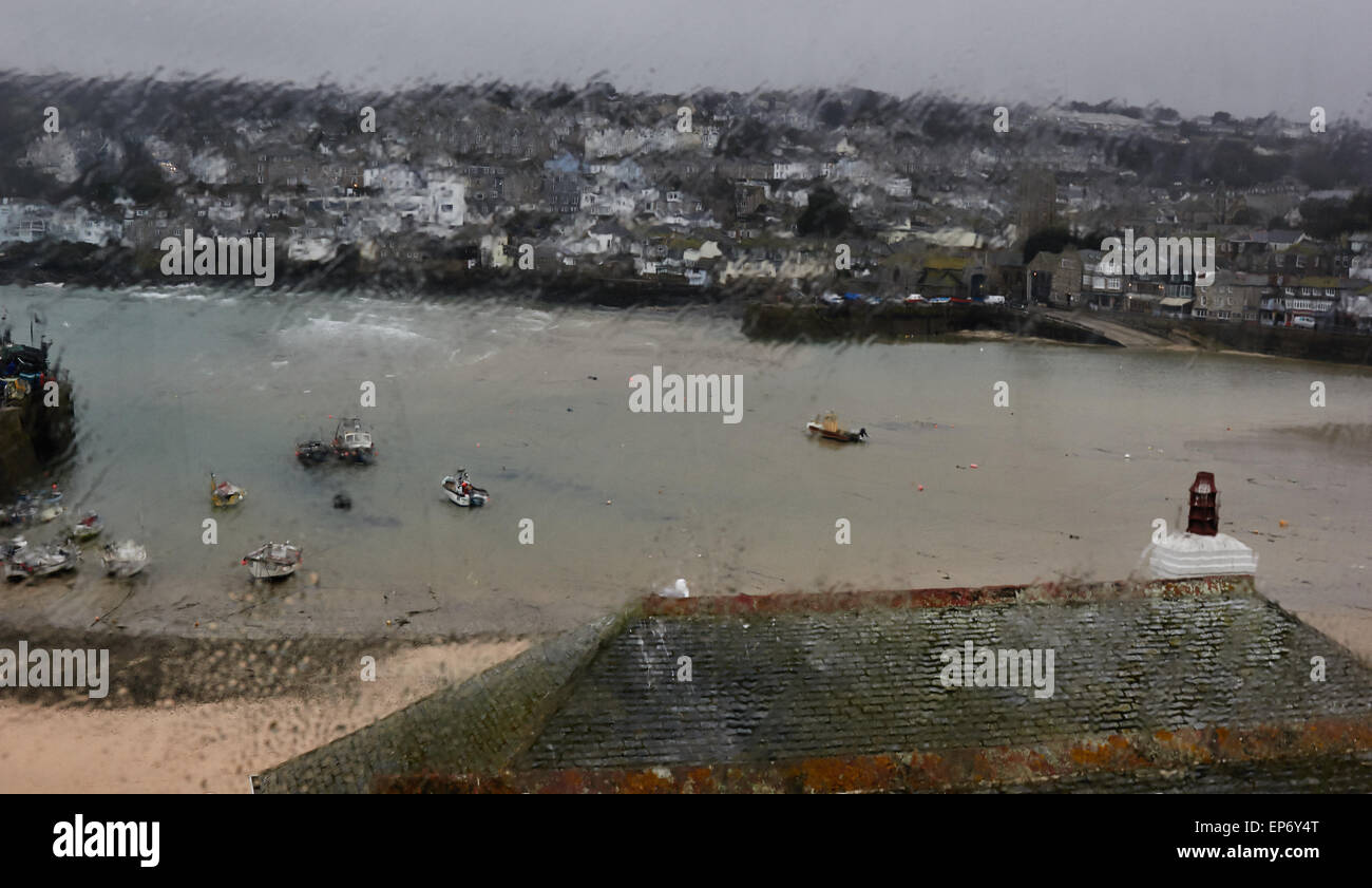 View of St Ives town and harbour beach through rain lashed window ...