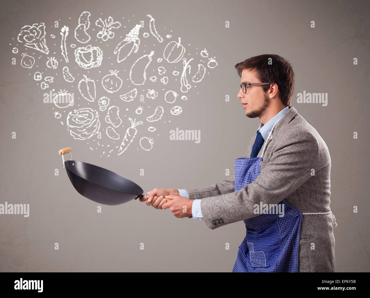 Attractive man cooking vegetables Stock Photo - Alamy