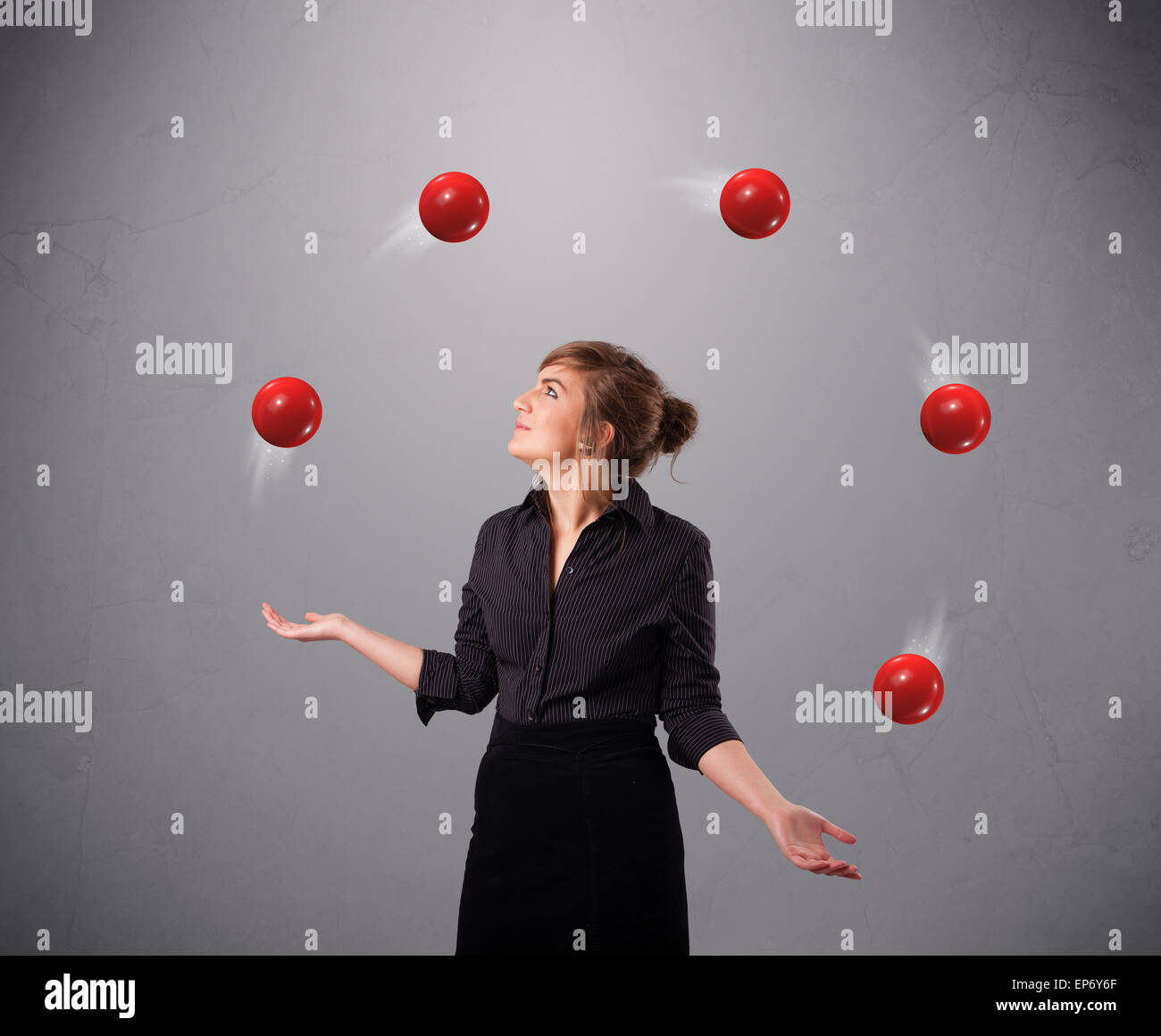 young girl standing and juggling with red balls Stock Photo - Alamy