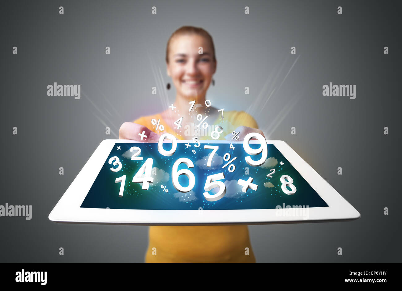 Young woman holding tablet with numbers Stock Photo - Alamy