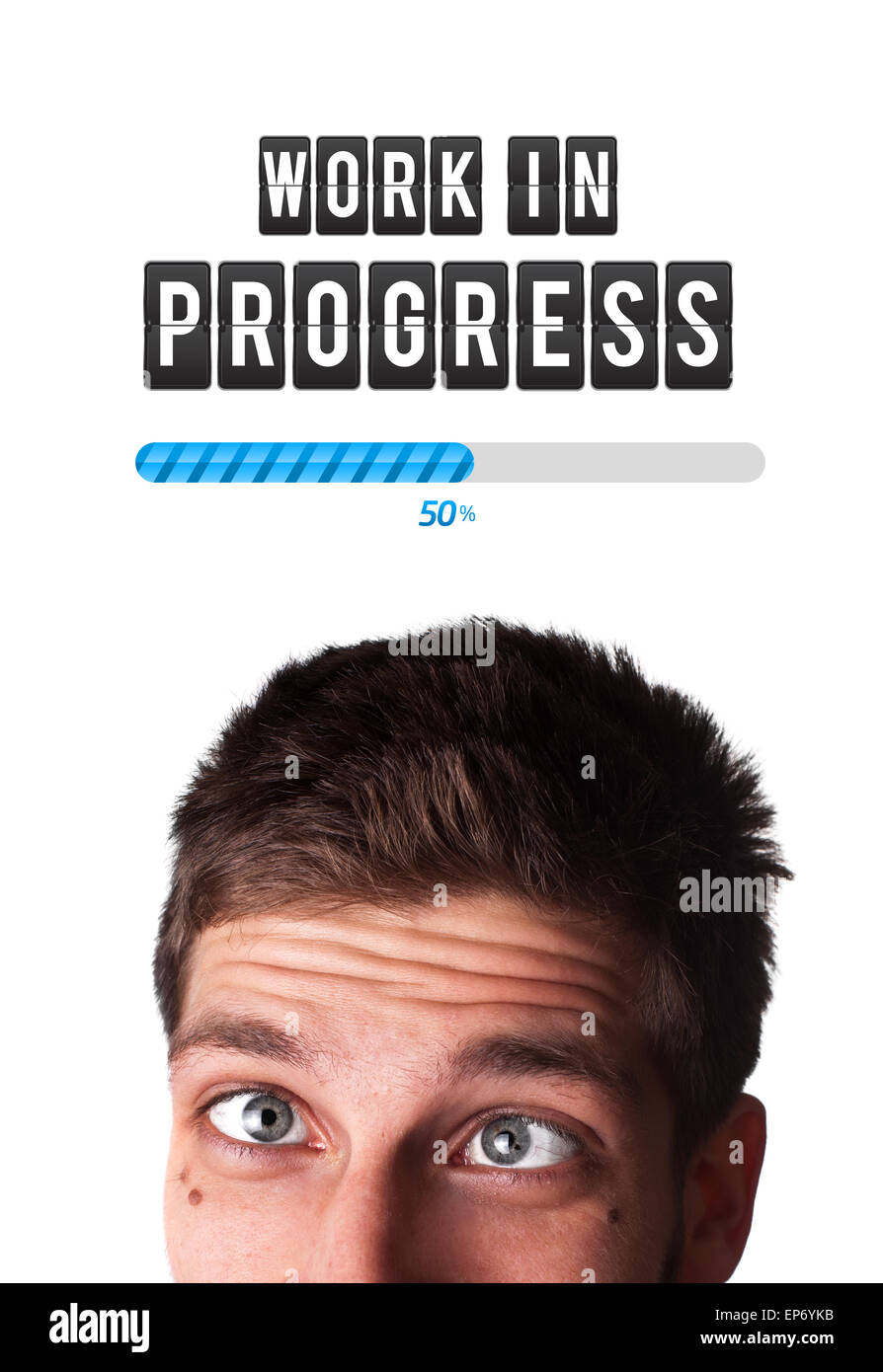 Young man with Work in progress mark over his head Stock Photo - Alamy