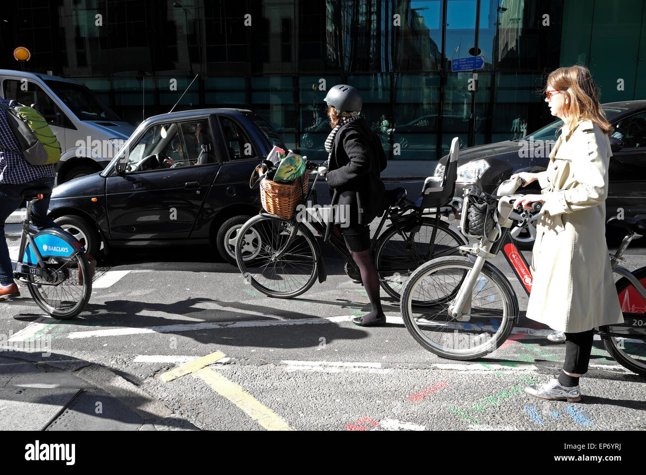 Workers cycling to work wait in heavy traffic on Chiswell Street in ...