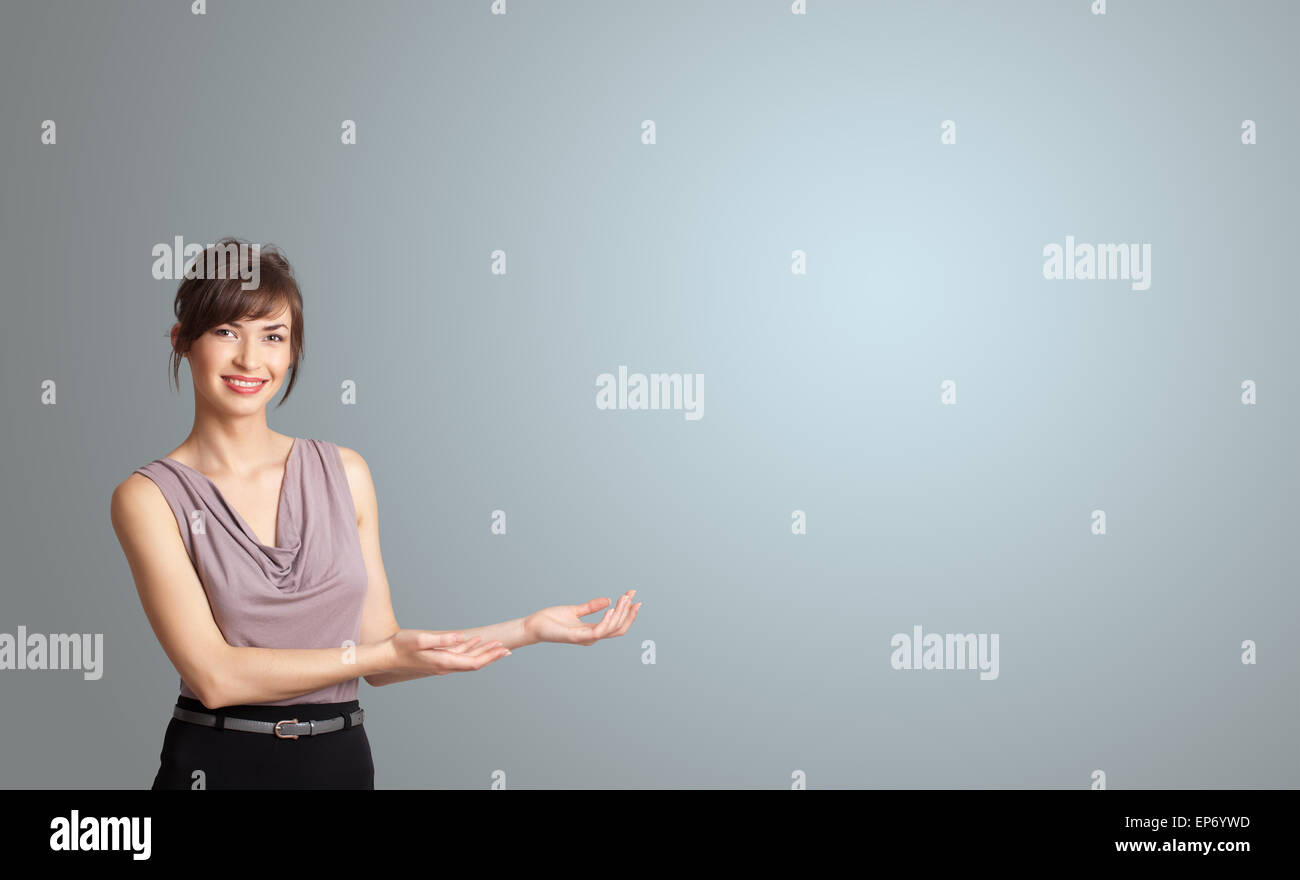 Pretty woman presenting copy space Stock Photo - Alamy