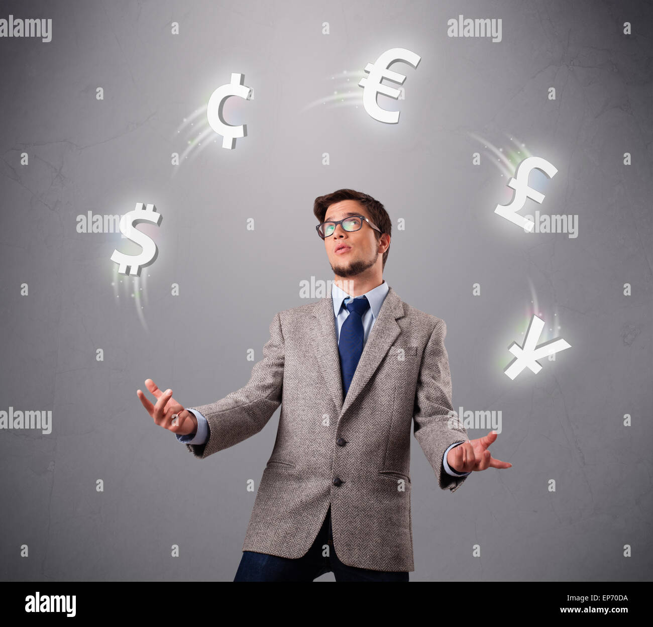 young man standing and juggling with currency icons Stock Photo - Alamy