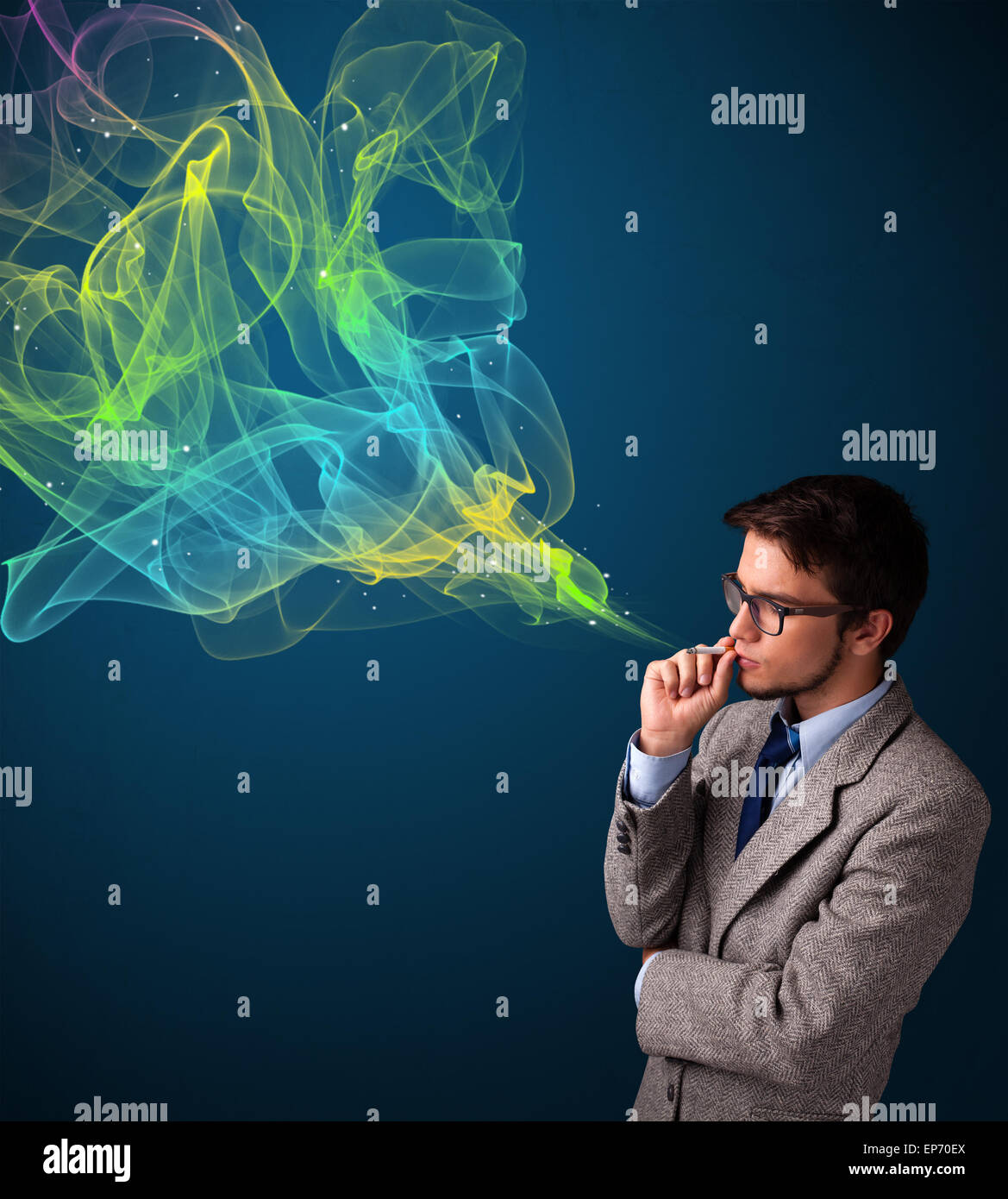 Handsome man smoking cigarette with colorful smoke Stock Photo - Alamy