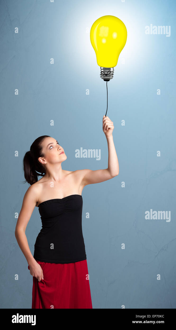 Pretty lady holding a light bulb balloon Stock Photo - Alamy