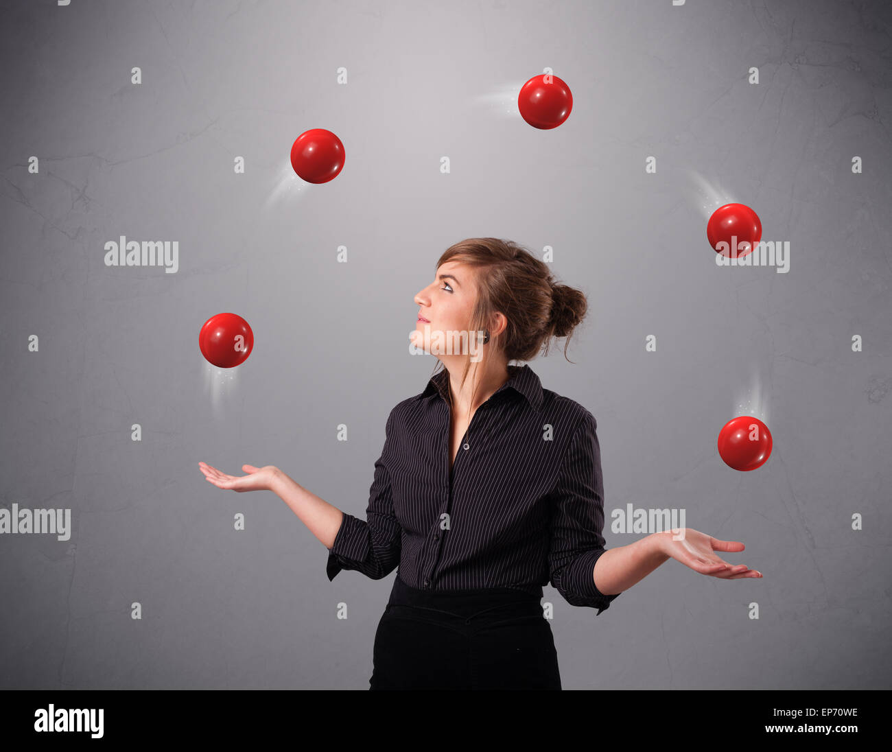 young girl standing and juggling with red balls Stock Photo - Alamy