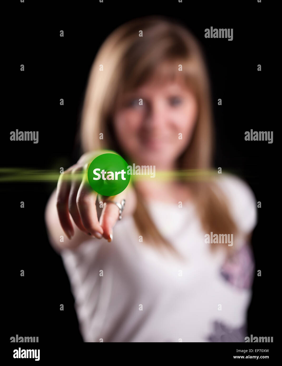 Woman pressing START button Stock Photo - Alamy