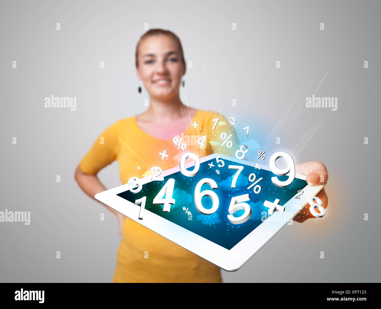 Young woman holding tablet with numbers Stock Photo - Alamy